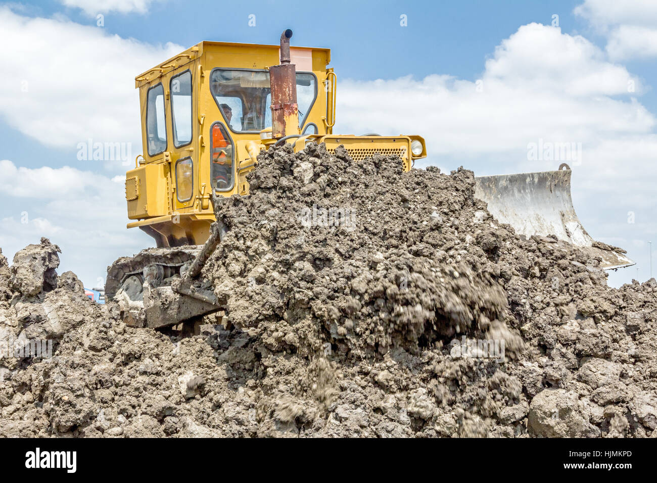 View on heavy bulldozer while he moving, leveling ground at ...