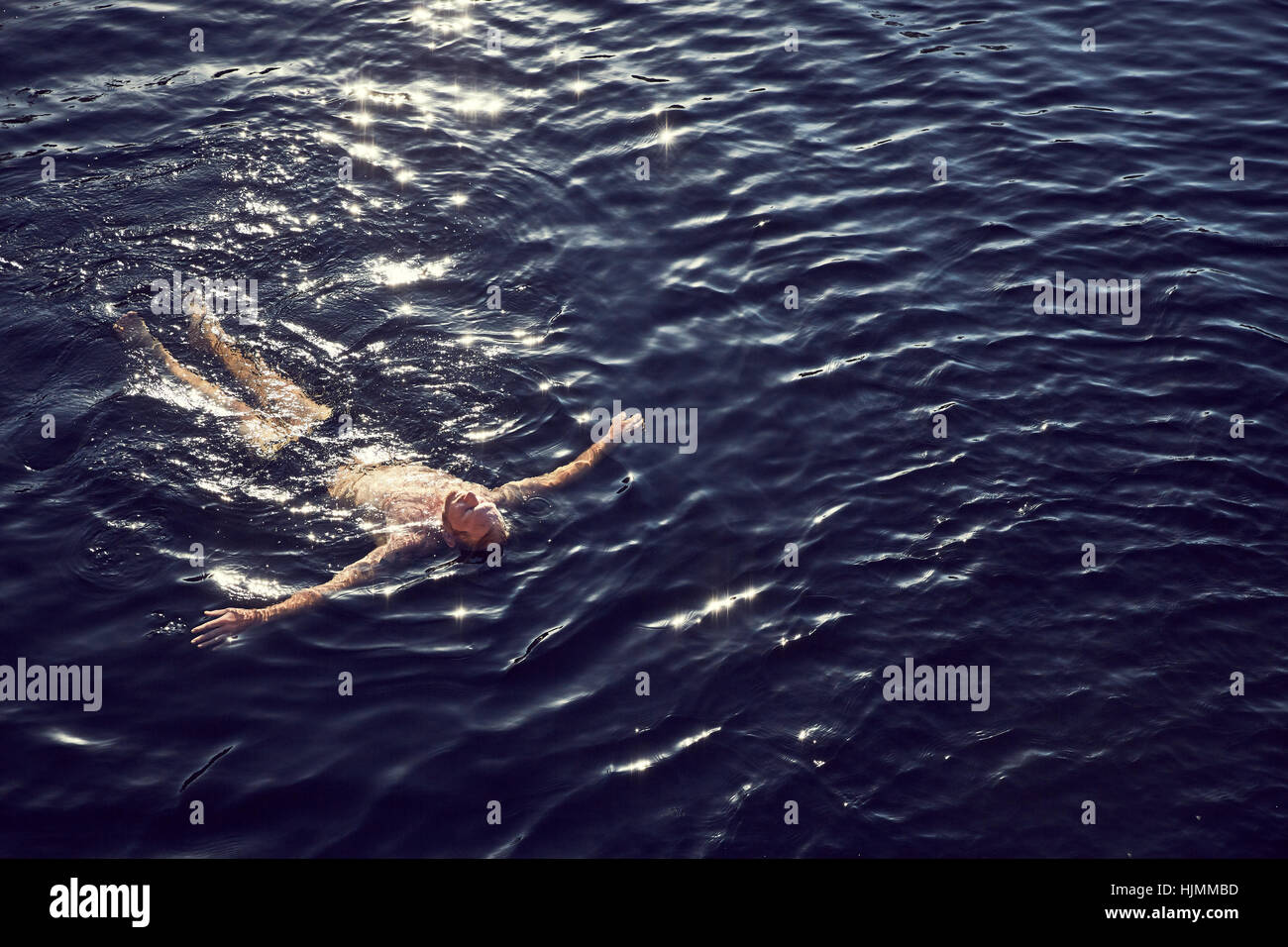 Man floating in water Stock Photo - Alamy