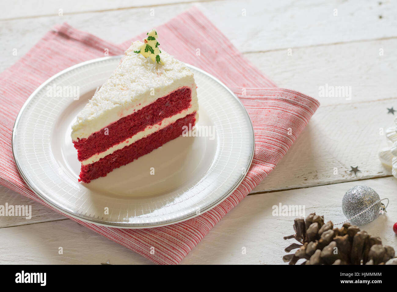 red velvet cake with white cream decoration on white table for holiday ...