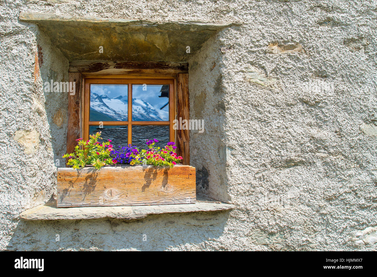 Window typical of the Swiss Alps, where the mountains are reflected in ...