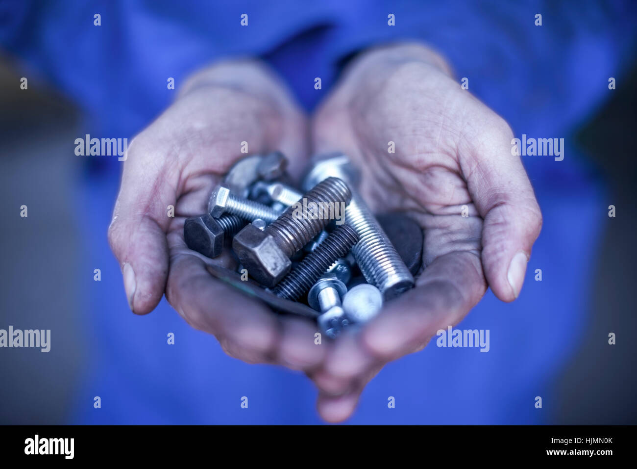 Hand holding bolts Stock Photo - Alamy