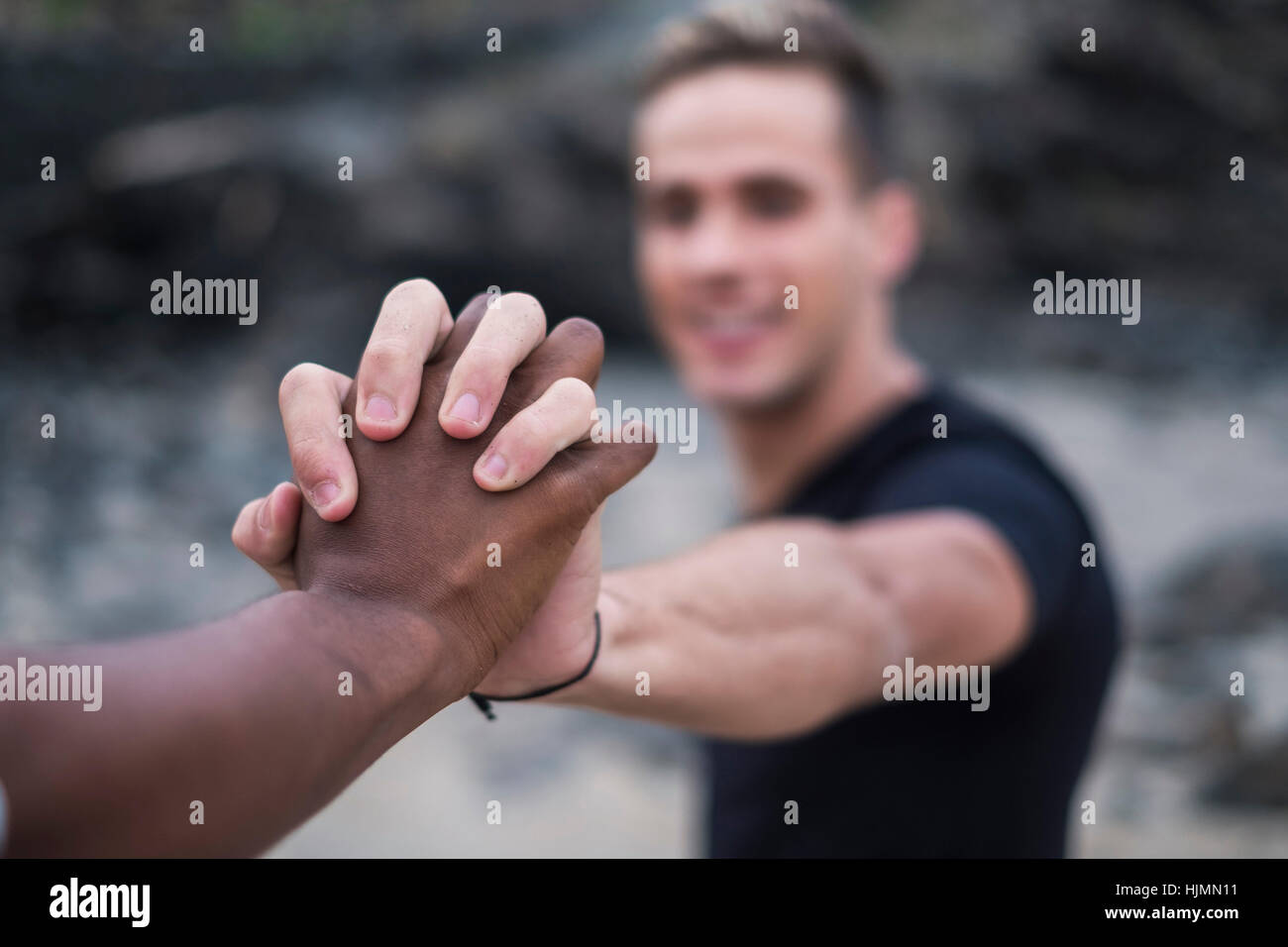 Two interlocked hands hi-res stock photography and images - Alamy