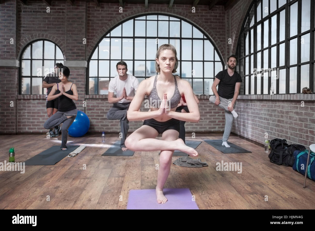 Woman instructing yoga class Stock Photo - Alamy
