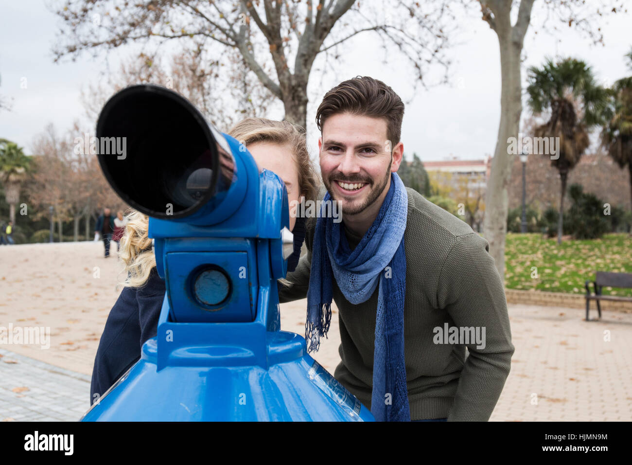 Two people looking through telescope hi-res stock photography and ...
