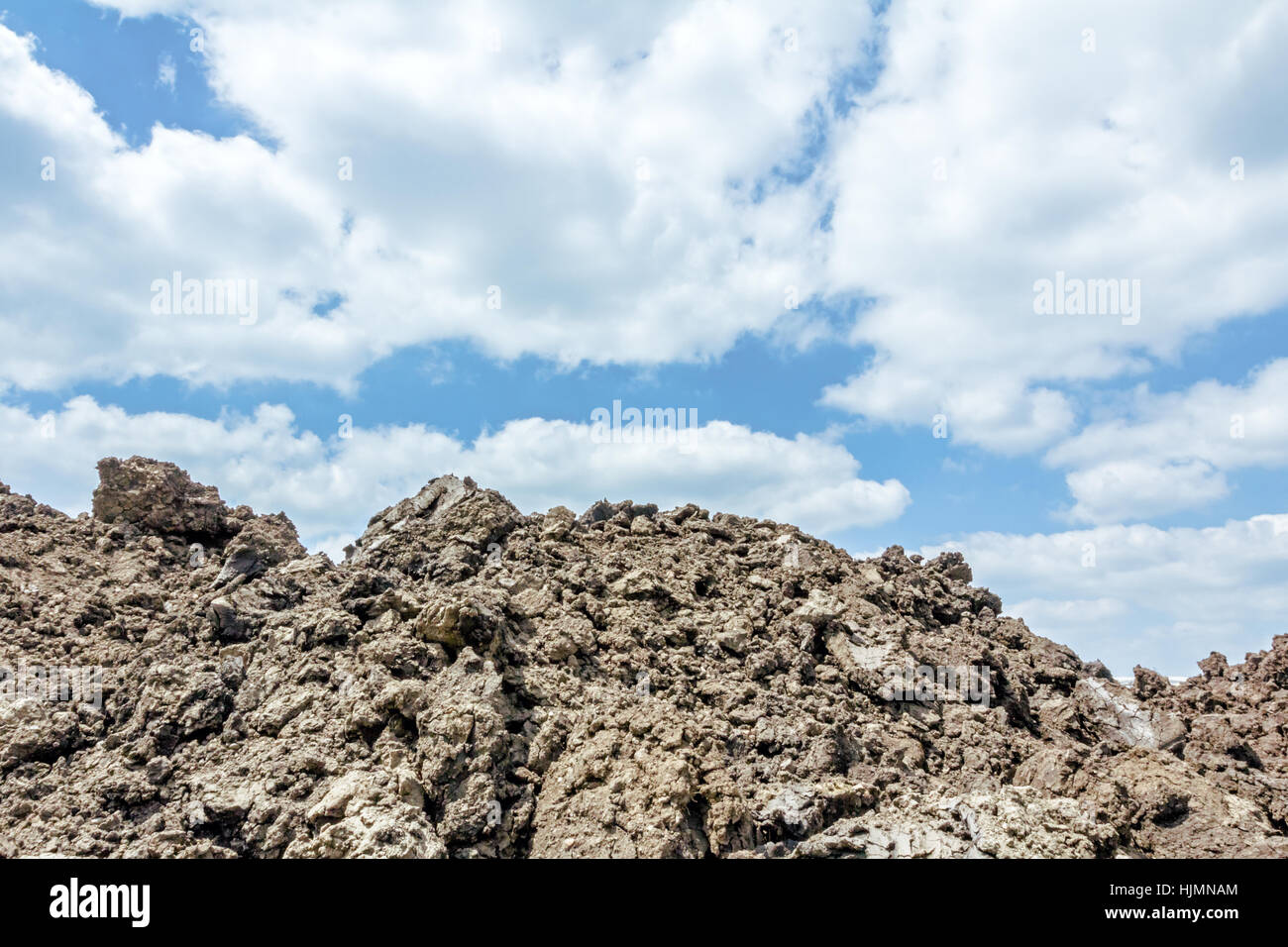 Soil layer on building site, blue sky, ground, wavy piles of earth, dry ...
