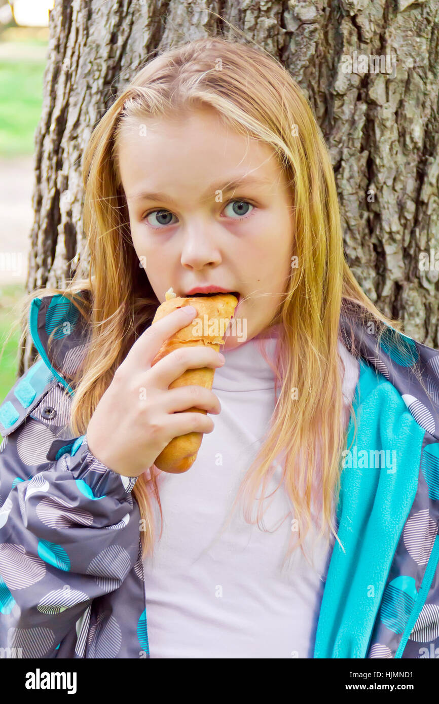 Photo of eating cute girl with blond hair Stock Photo - Alamy