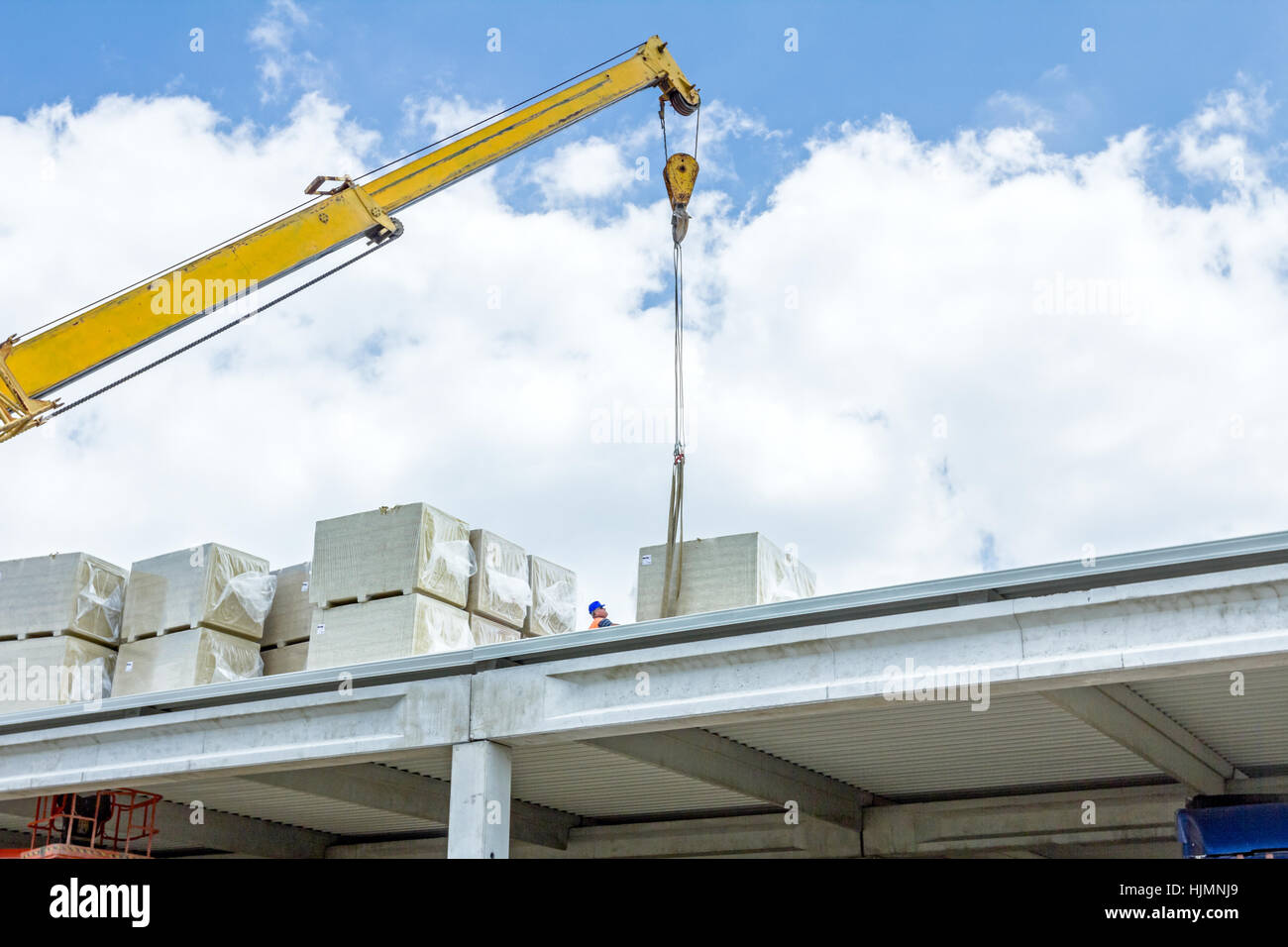 Mobile crane is loading cargo. View on construction site with machinery ...