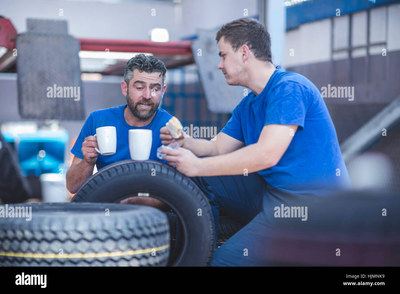 Two mechanics on a coffee break in workshop Stock Photo - Alamy