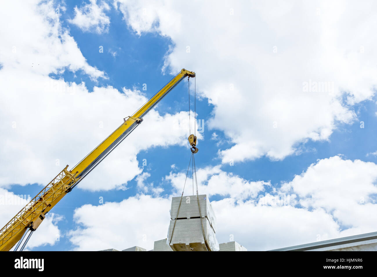 Mobile crane is loading cargo. View on construction site with machinery ...