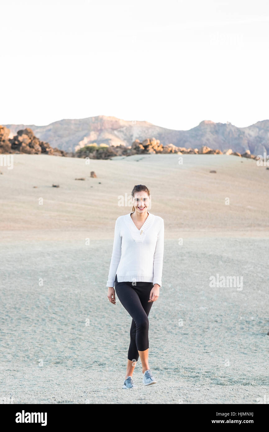 Young woman taking a walk in desert Stock Photo - Alamy