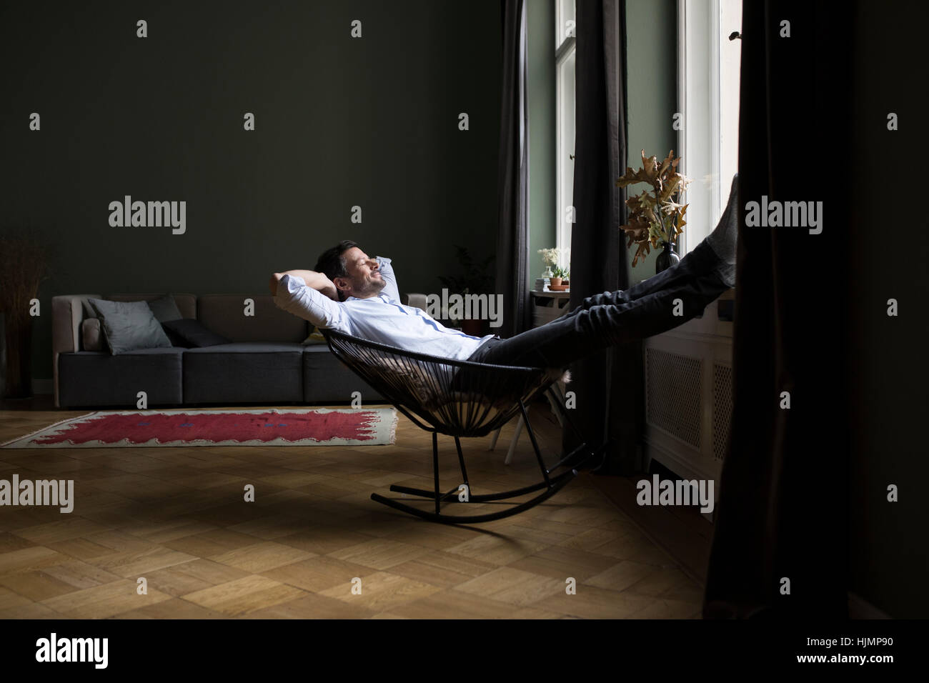 Mature man sitting in rocking hi-res stock photography and images - Alamy