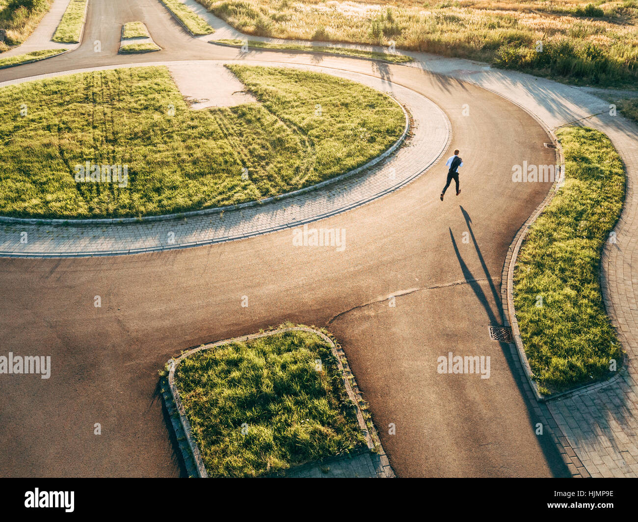 Businessman running in roundabout Stock Photo - Alamy
