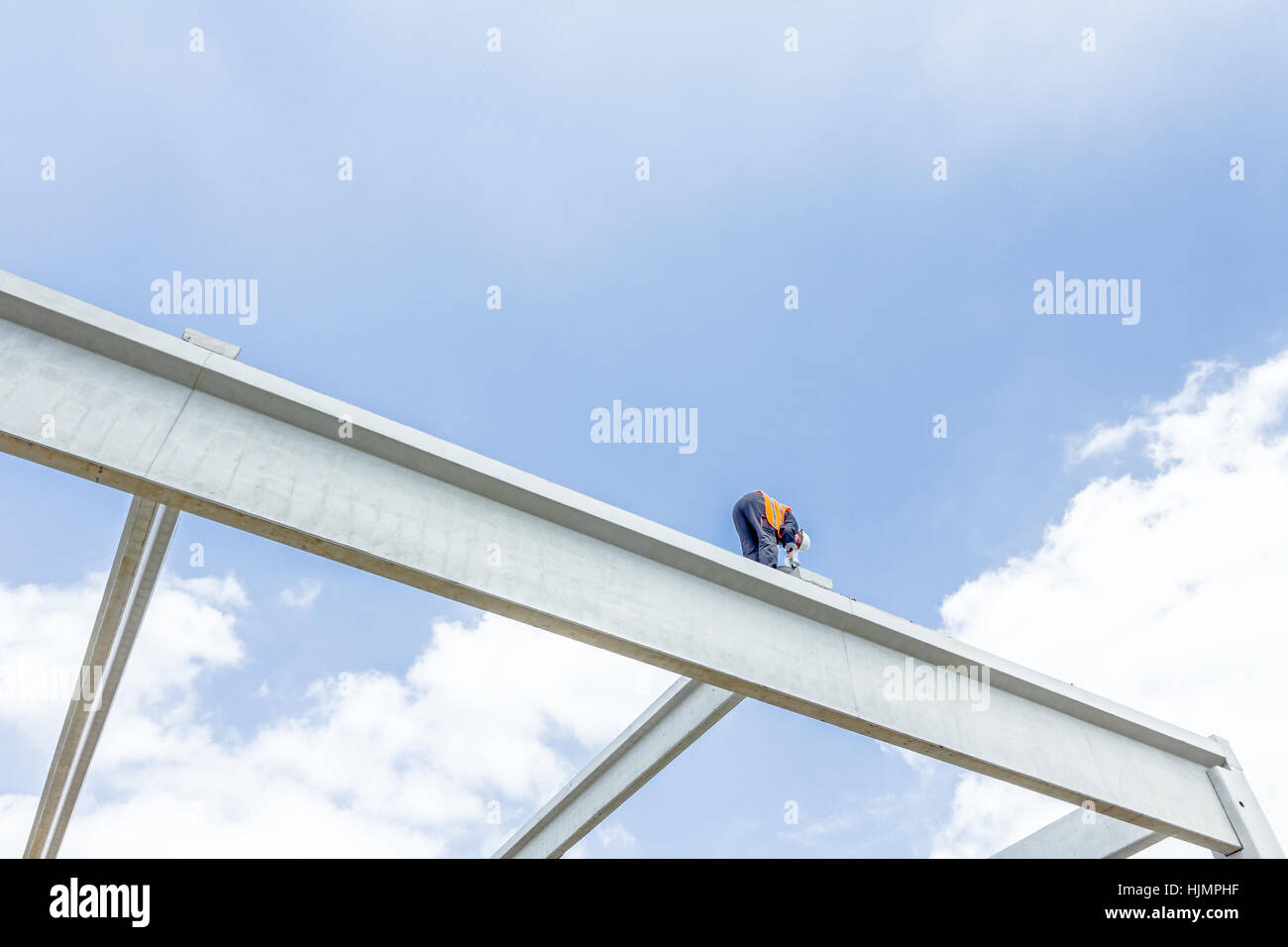 Construction worker is walking over on building concrete beam without ...