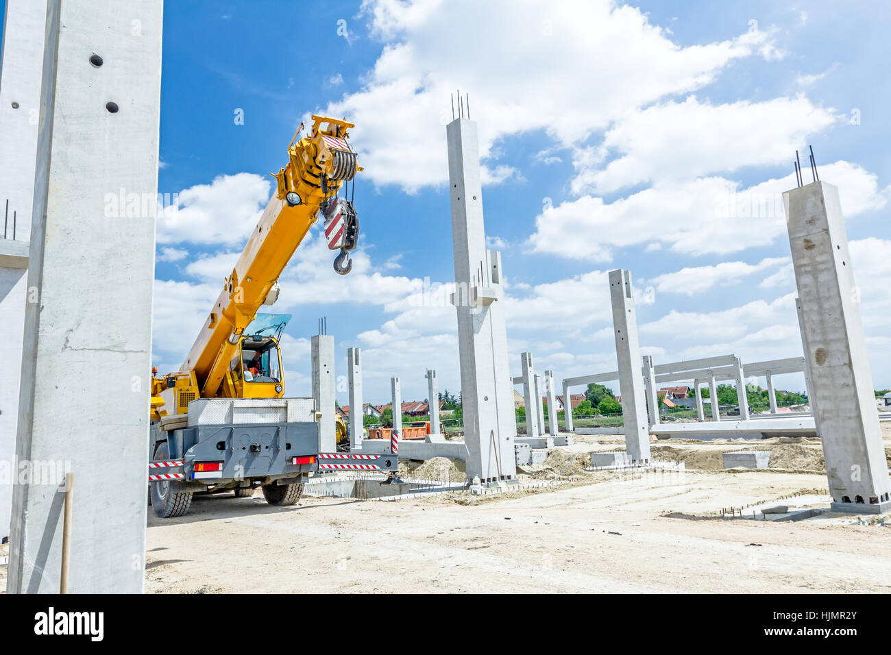 Crane arm is ready for operating to assembly concrete pillars on new ...