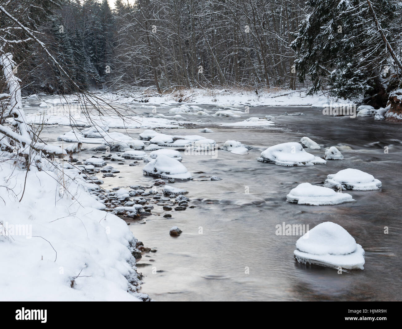 Frozen winter river landscape with ice and snow Stock Photo - Alamy