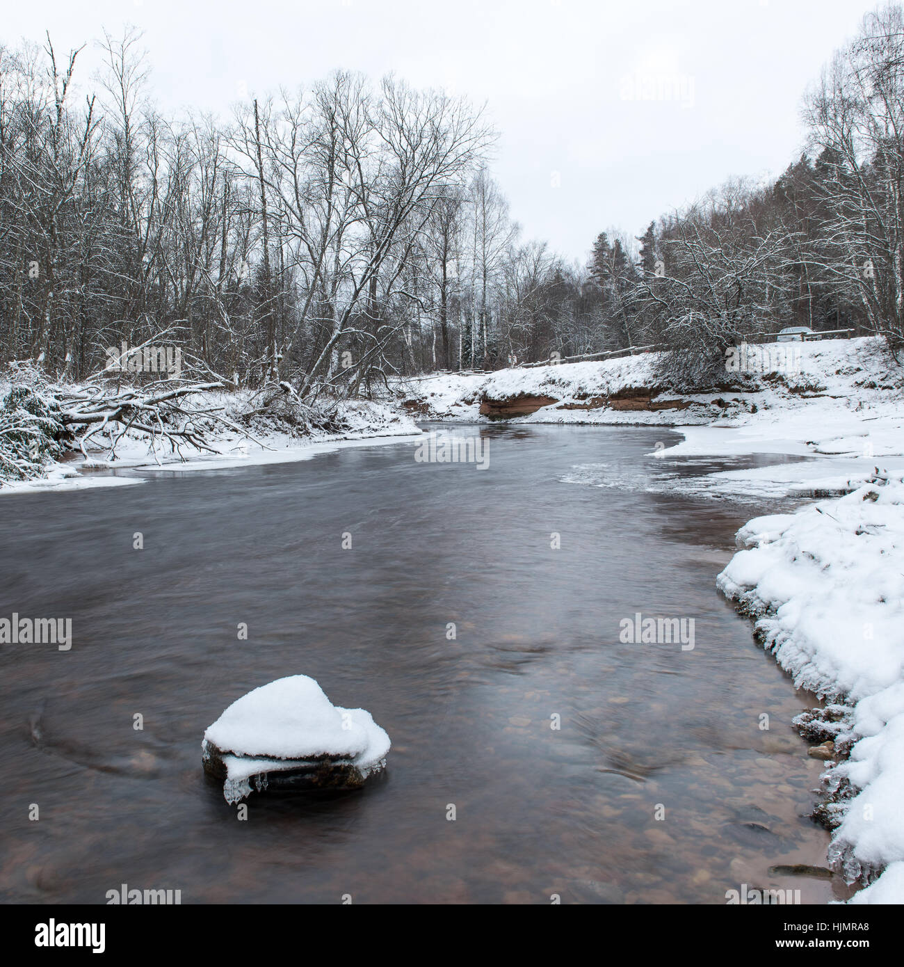 Frozen winter river landscape with ice and snow Stock Photo - Alamy