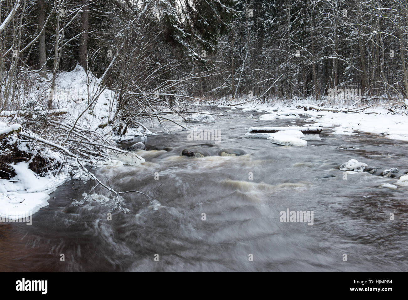 Frozen winter river landscape with ice and snow Stock Photo - Alamy