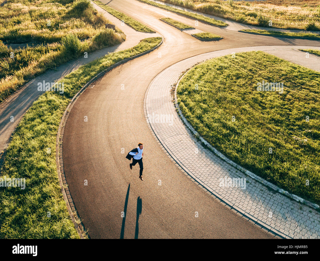 Businessman running in roundabout Stock Photo - Alamy