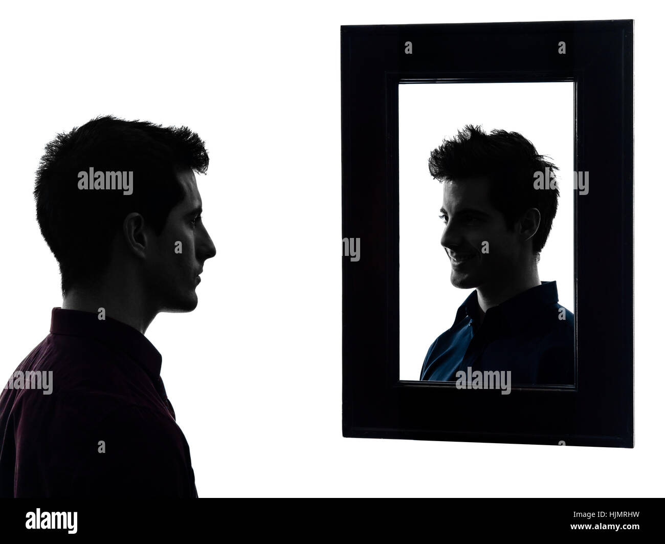 man in front of his mirror serious in shadow white background Stock ...