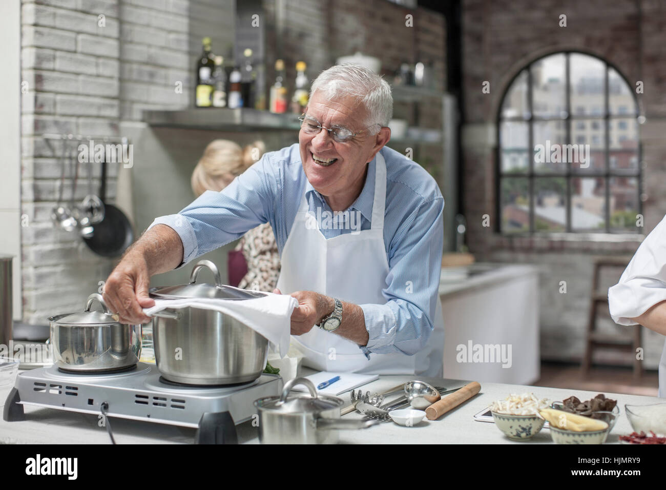 Senior man taking a cooking course Stock Photo - Alamy