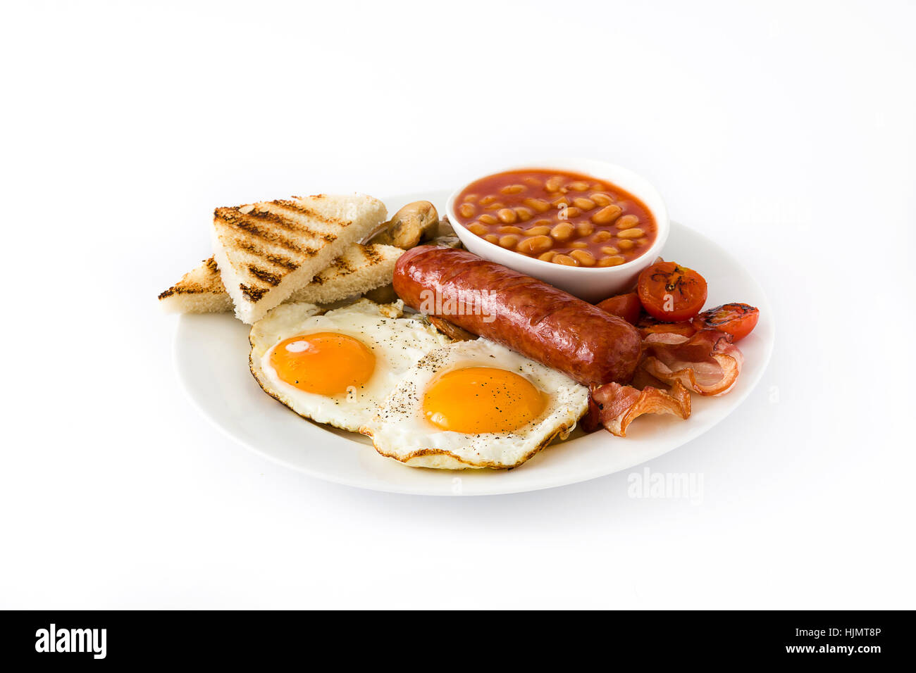Traditional full English breakfast with fried eggs, sausages, beans ...