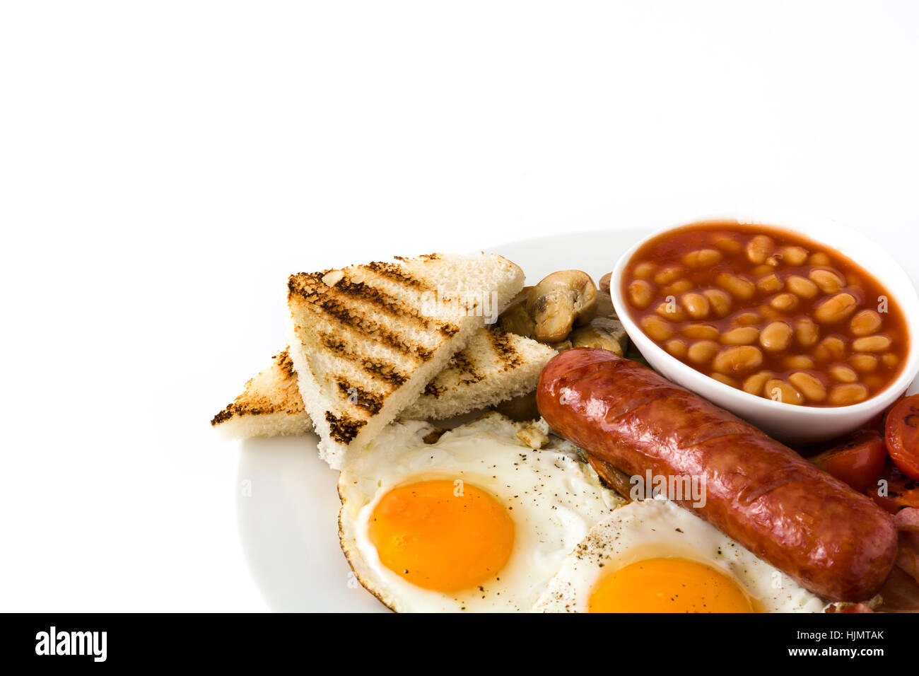 Traditional full English breakfast with fried eggs, sausages, beans ...