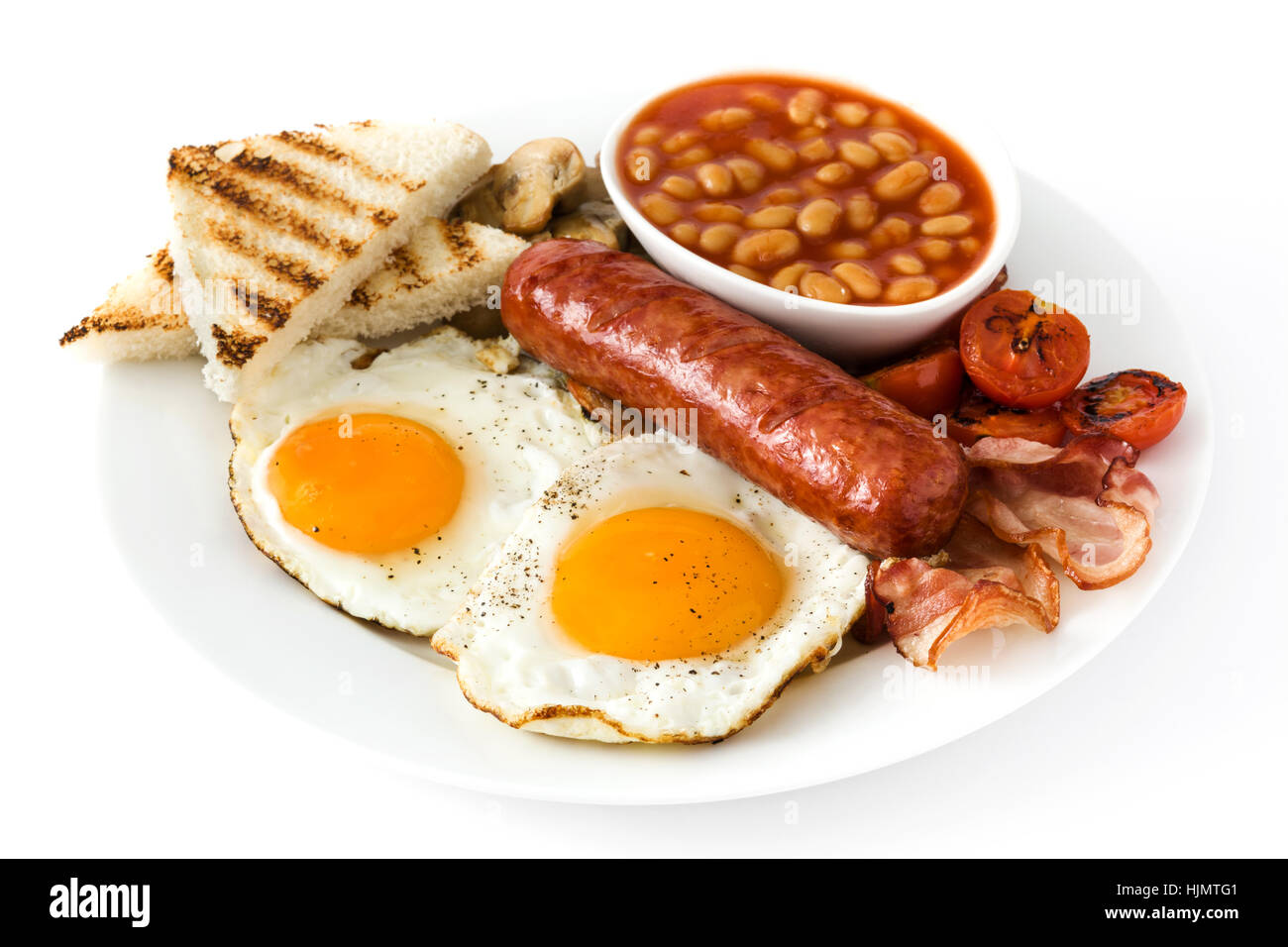 Traditional full English breakfast with fried eggs, sausages, beans ...