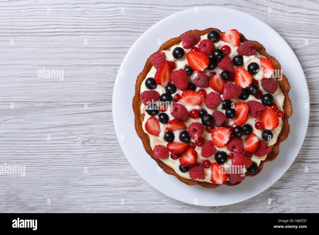 Delicious tart with fresh strawberries, raspberries and currants on the ...