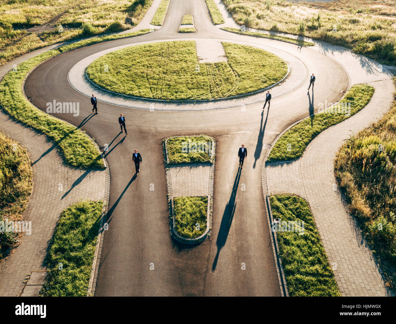 Multiple businessmen walking in roundabout Stock Photo - Alamy