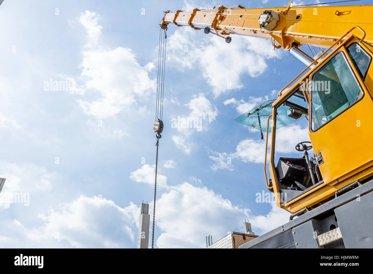 Side view on open cabin of the yellow mobile crane with erected long ...