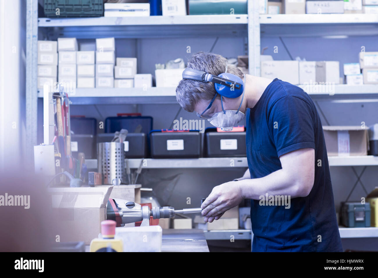 Man at work in a factory Stock Photo - Alamy