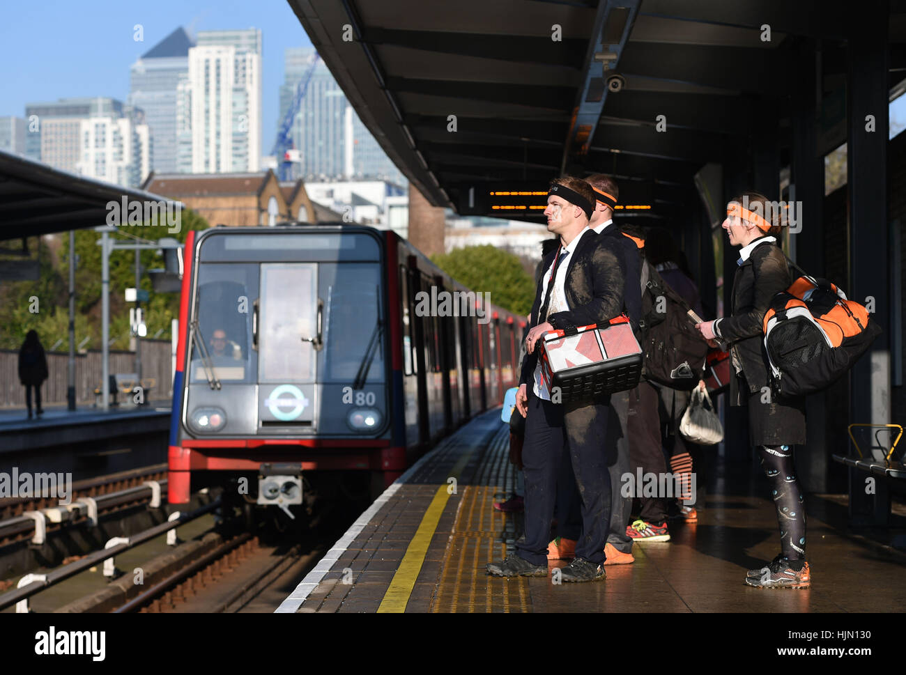 Competitors dressed in suits leave Mudchute DLR station in London after ...