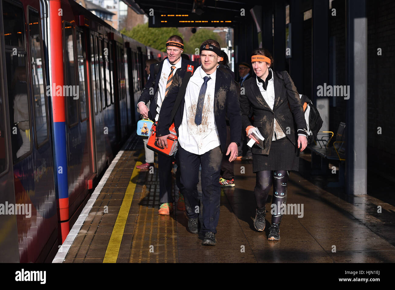 Competitors dressed in suits leave Mudchute DLR station in London after ...