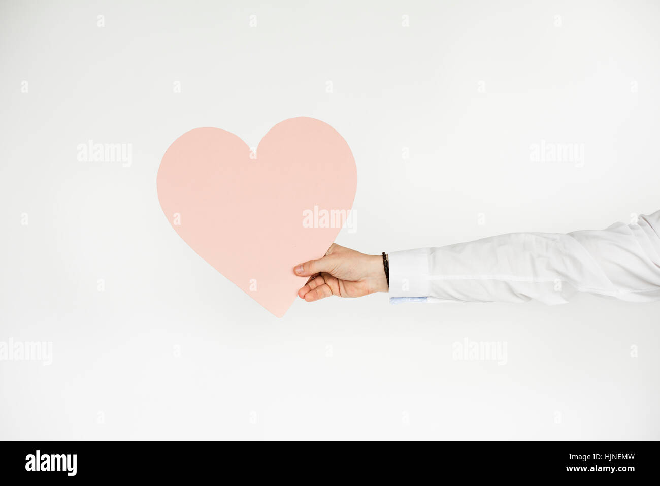 Man's arm holding a heart shape Stock Photo - Alamy