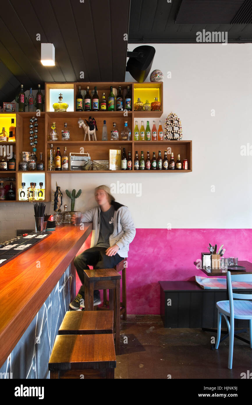 Interior of restaurant facing bar with patron at bar. Radio Mexico ...