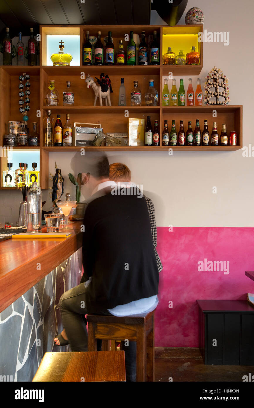 Interior of restaurant facing bar with patrons at bar. Radio Mexico ...