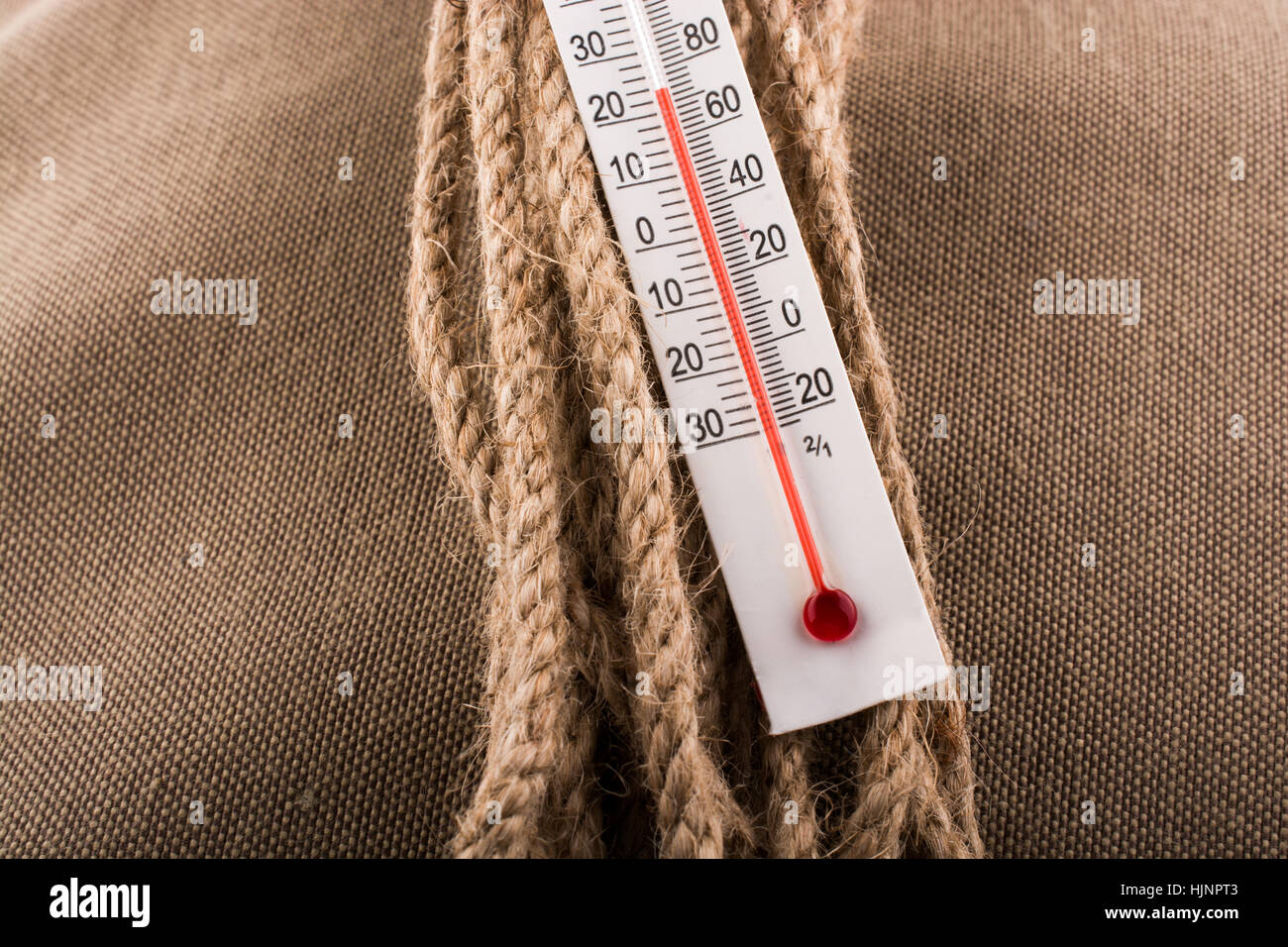 Thermometer placed on a brown rope on a fabric background Stock Photo ...