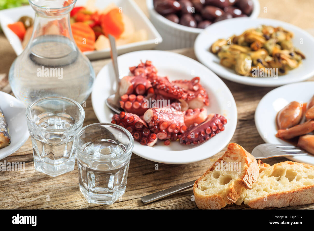 Glasses of ouzo and appetizers Stock Photo - Alamy