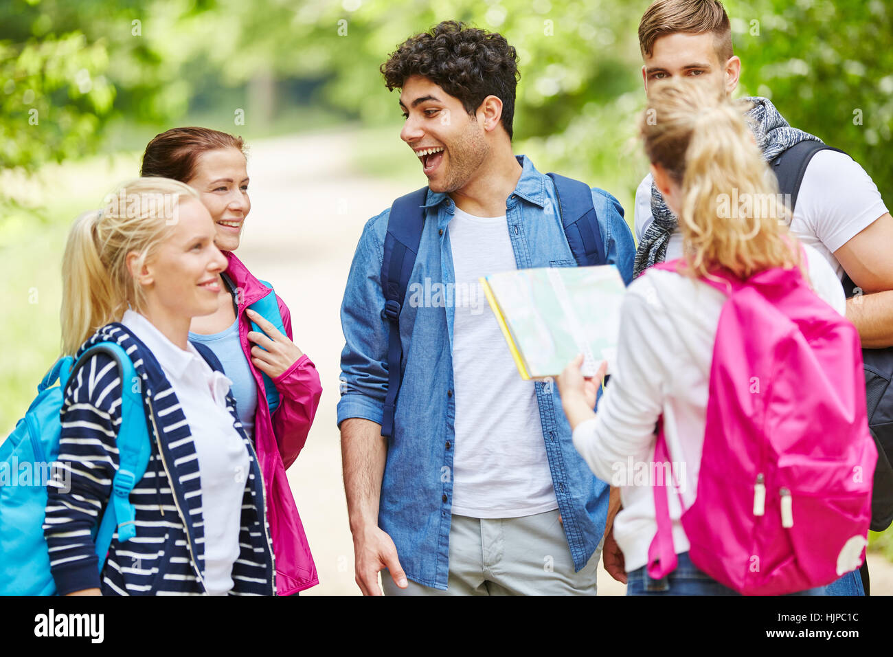 Hiking group having fun with tour guide Stock Photo - Alamy