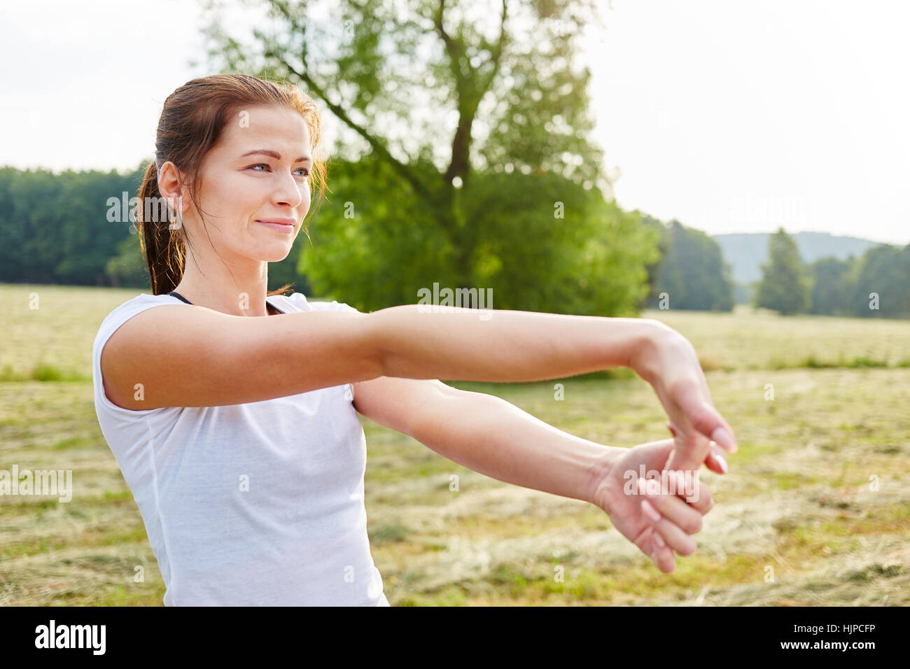 Young woman stretching her hand before fitness training Stock Photo - Alamy