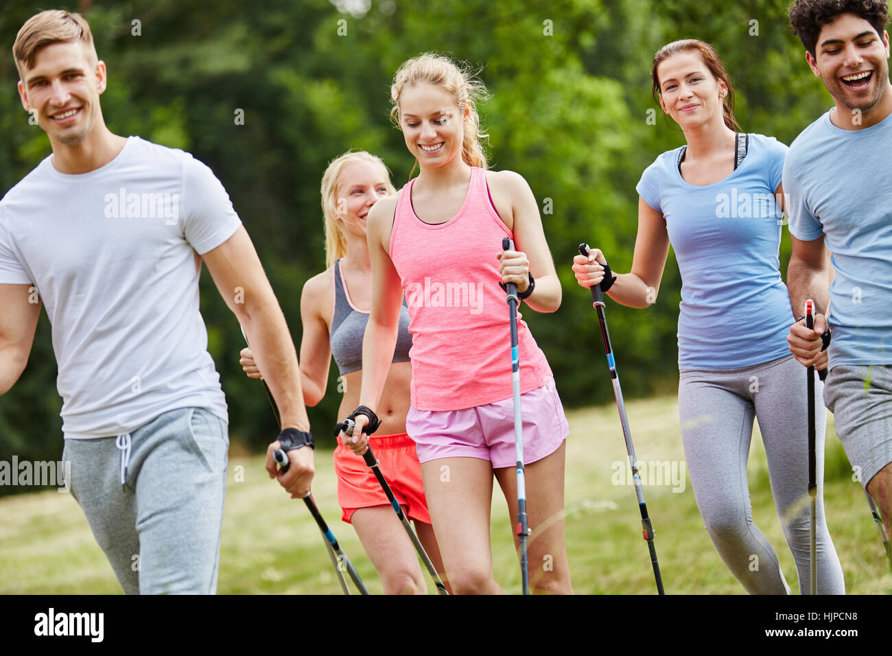 Friends walking together in the park hi-res stock photography and ...