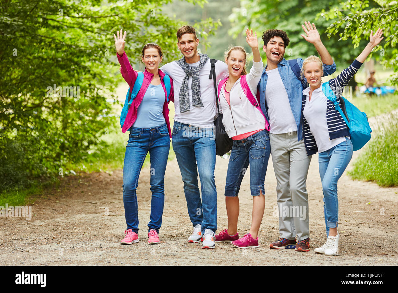 Friends waving and smiling with joy as a group Stock Photo - Alamy