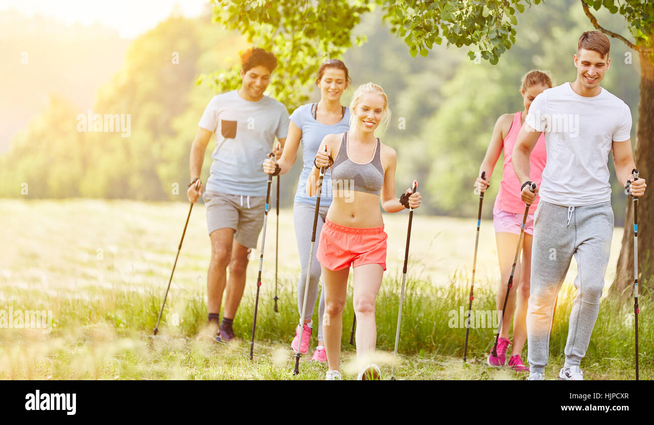 Group in summer nordic walking in their fitness class Stock Photo - Alamy