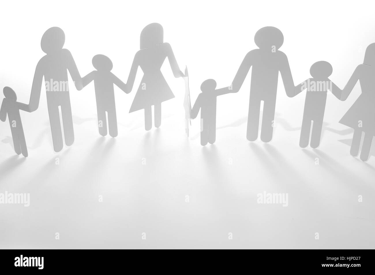 Family paper chain cutout holding hands Stock Photo - Alamy