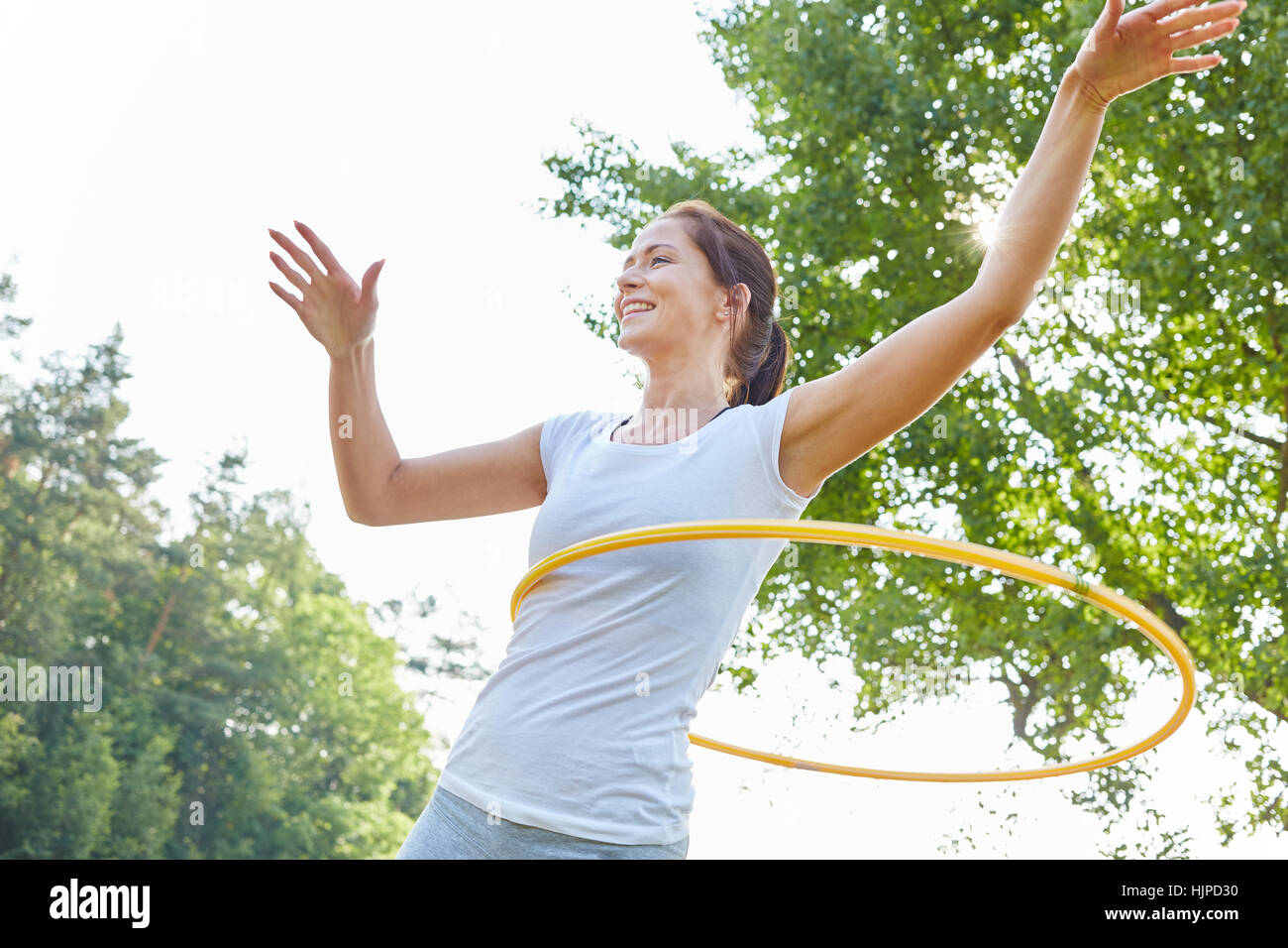 Active woman having fun with hoop and training Stock Photo - Alamy