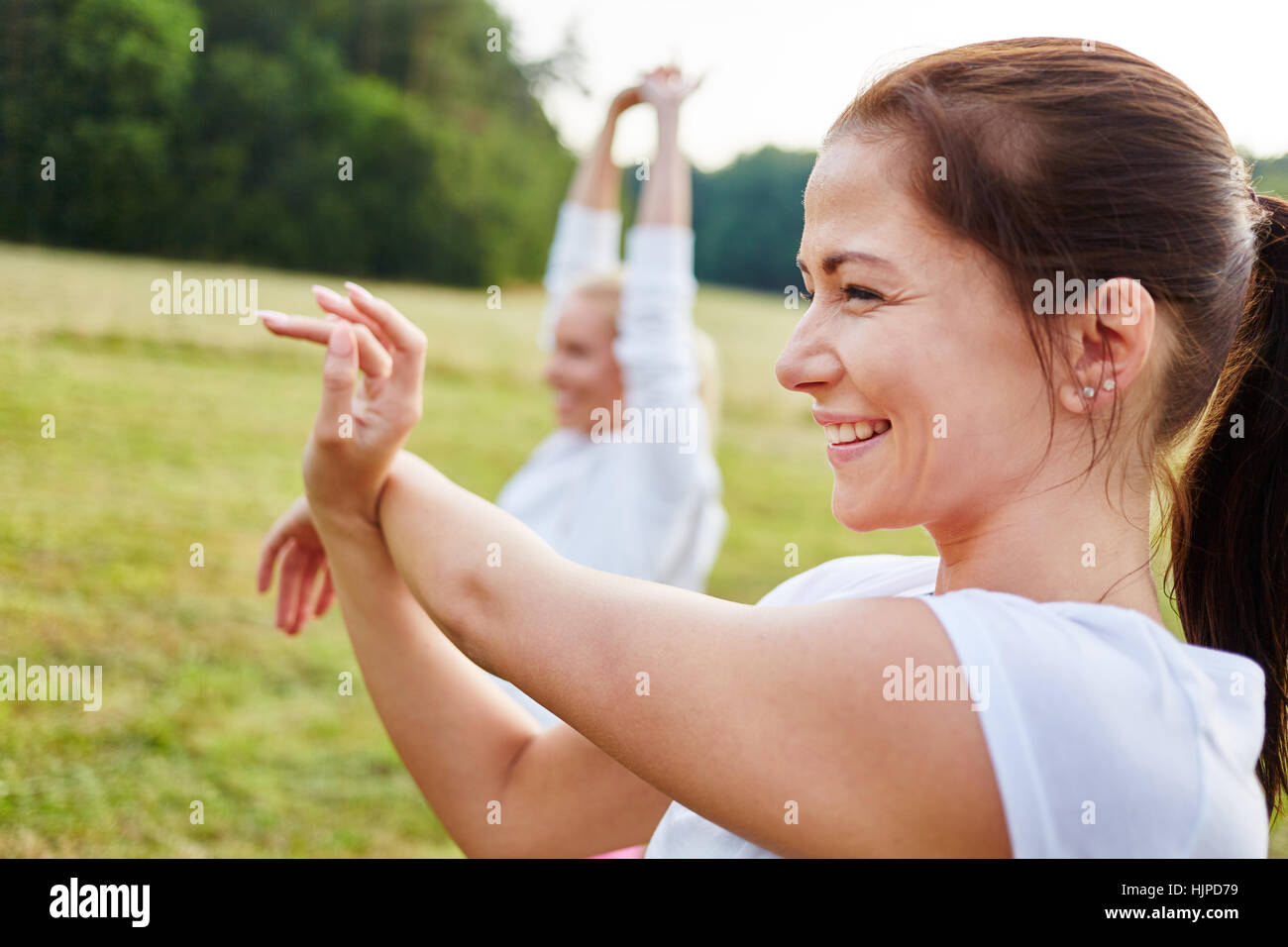 Vital women stretching with joy and working out Stock Photo - Alamy