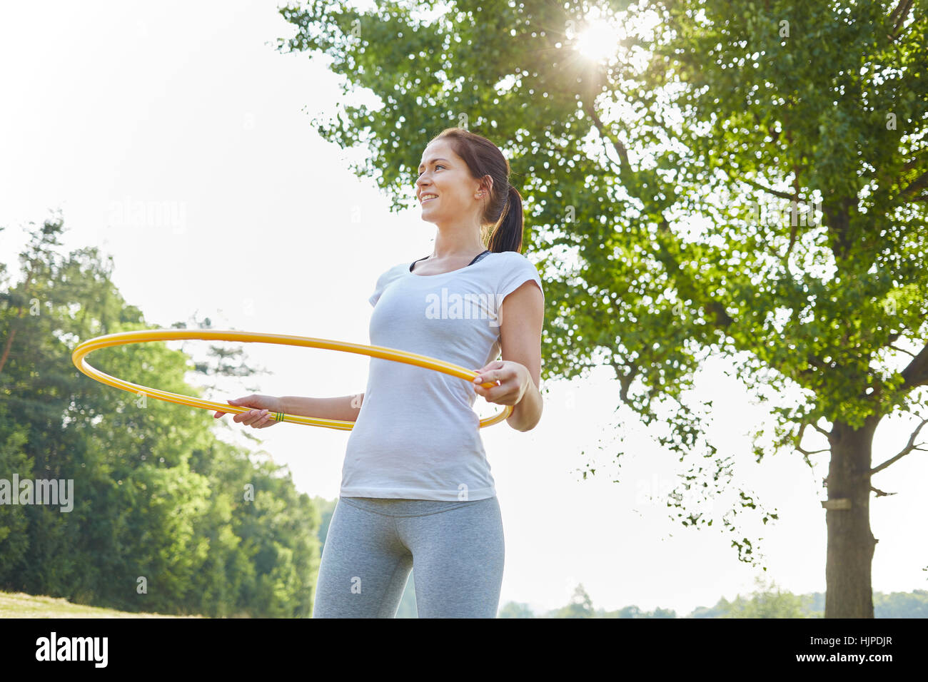 Young woman does gymnastics with hoop for fitness training Stock Photo ...