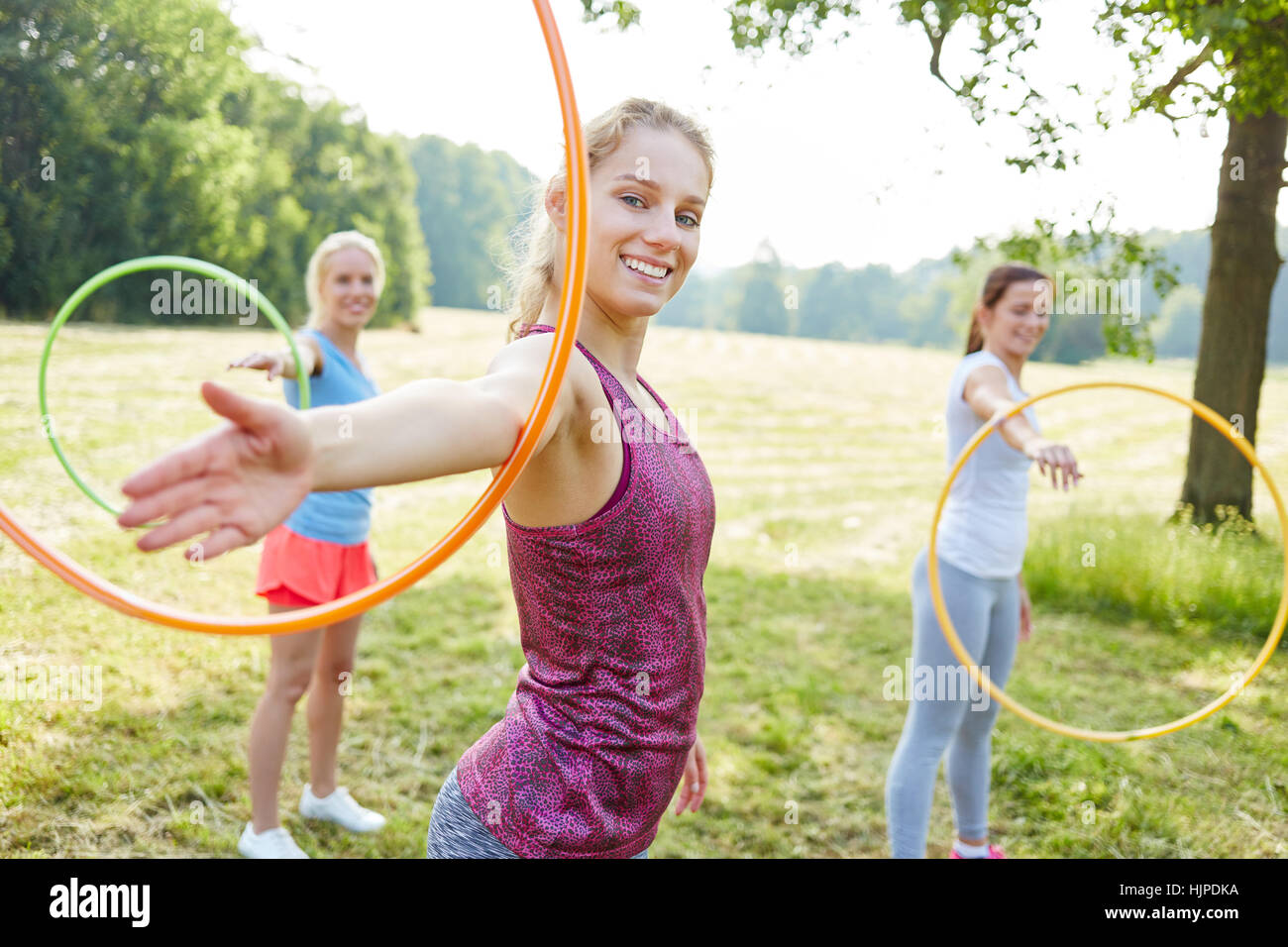 Women playing with hoops and having fun at the park Stock Photo - Alamy