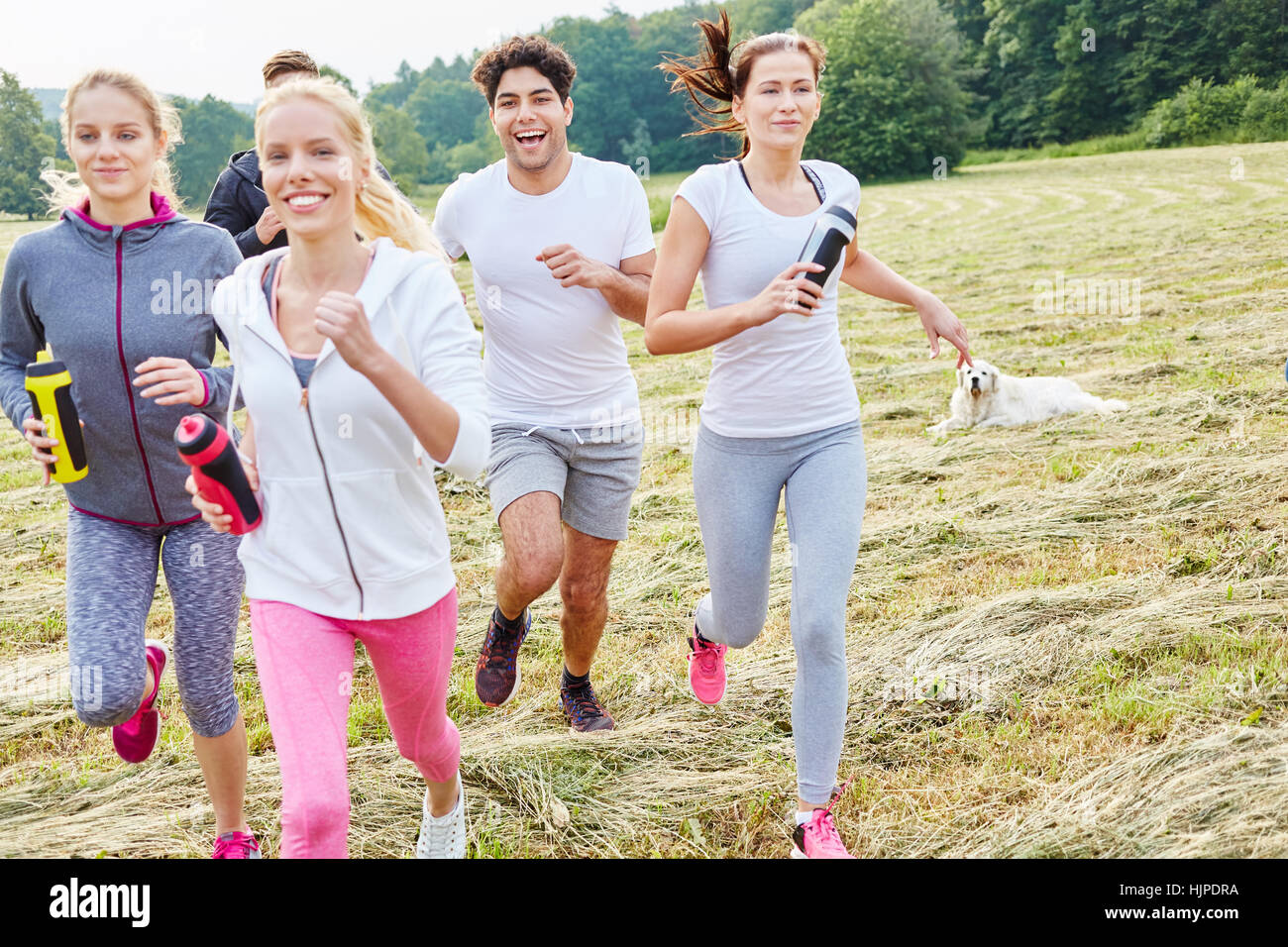 Group of people jogging in run training Stock Photo - Alamy