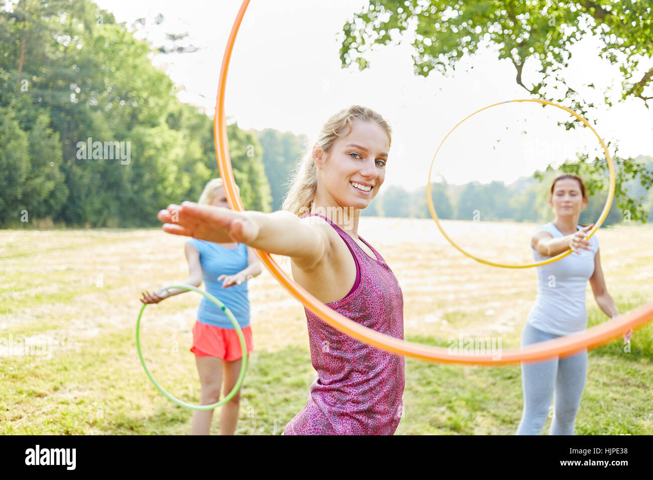 Women training their agility with hoops in fitness class Stock Photo ...